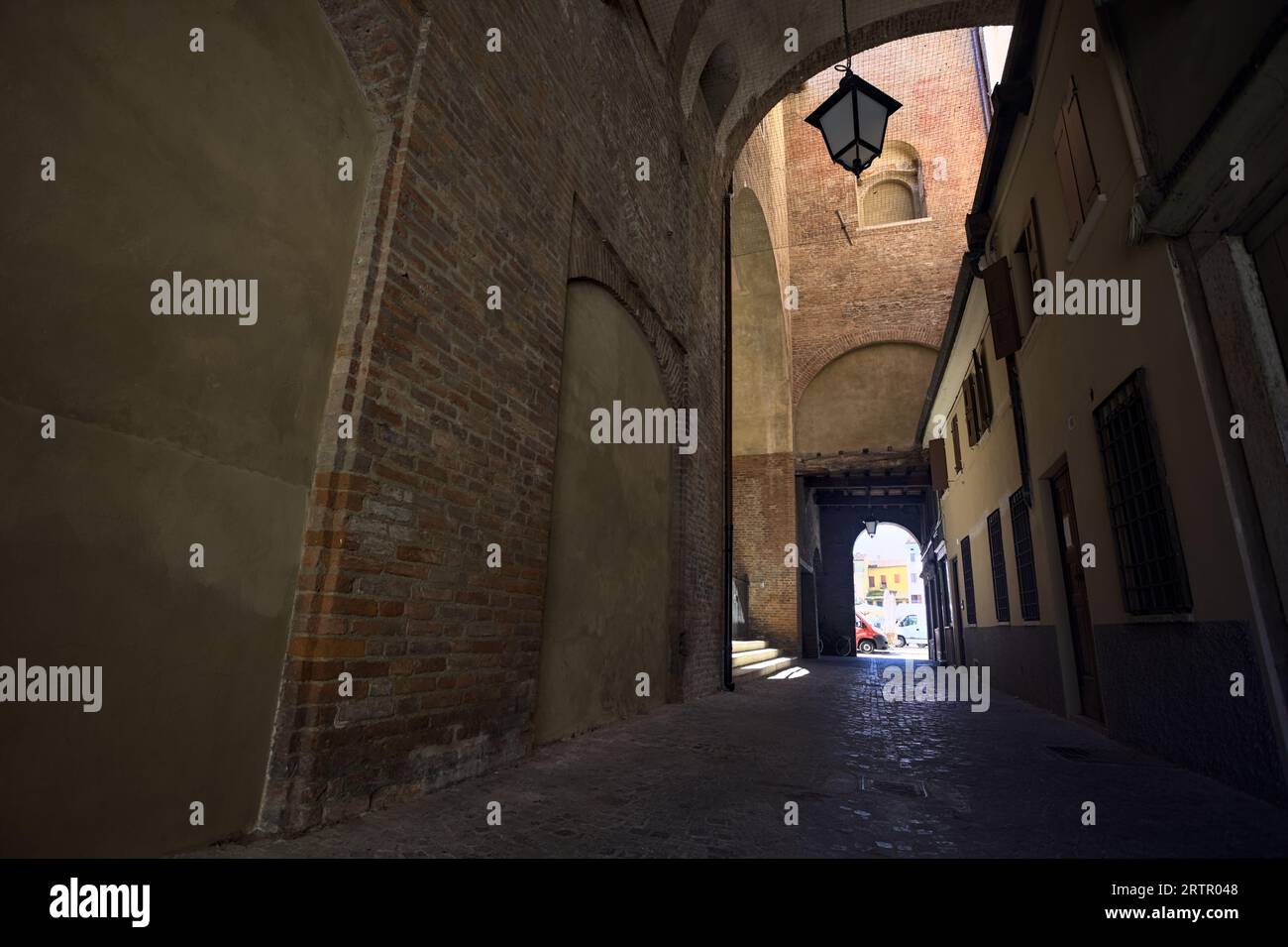 Covered alleyway in a palace with windows and doors in it on a sunny ...