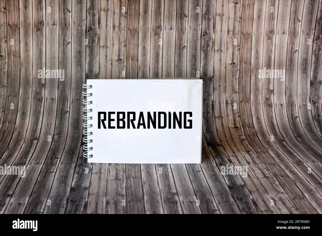 The word REBRANDING on a notepad and wooden background Stock Photo - Alamy