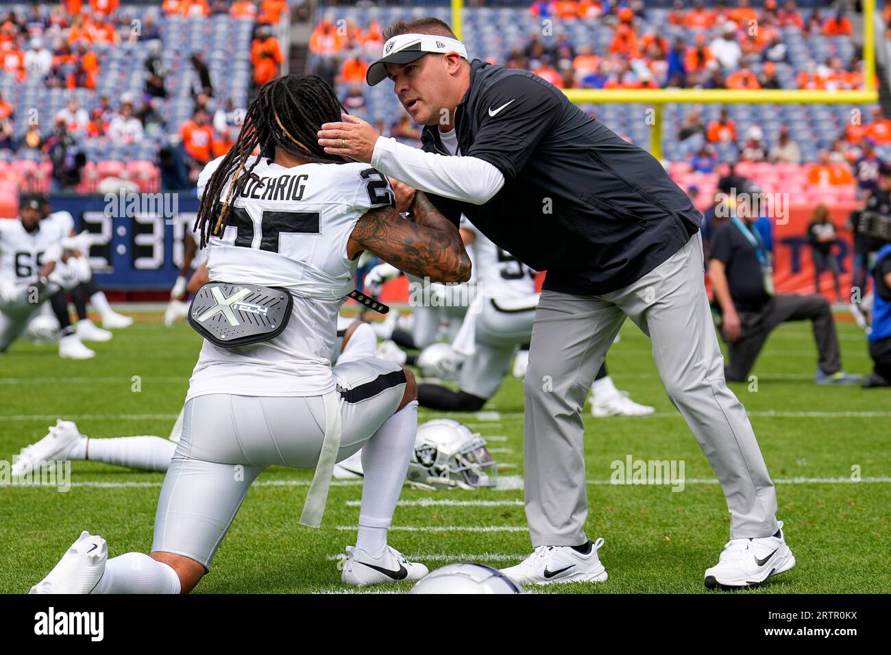 Las Vegas Raiders head coach Josh McDaniels greets safety Tre'von ...