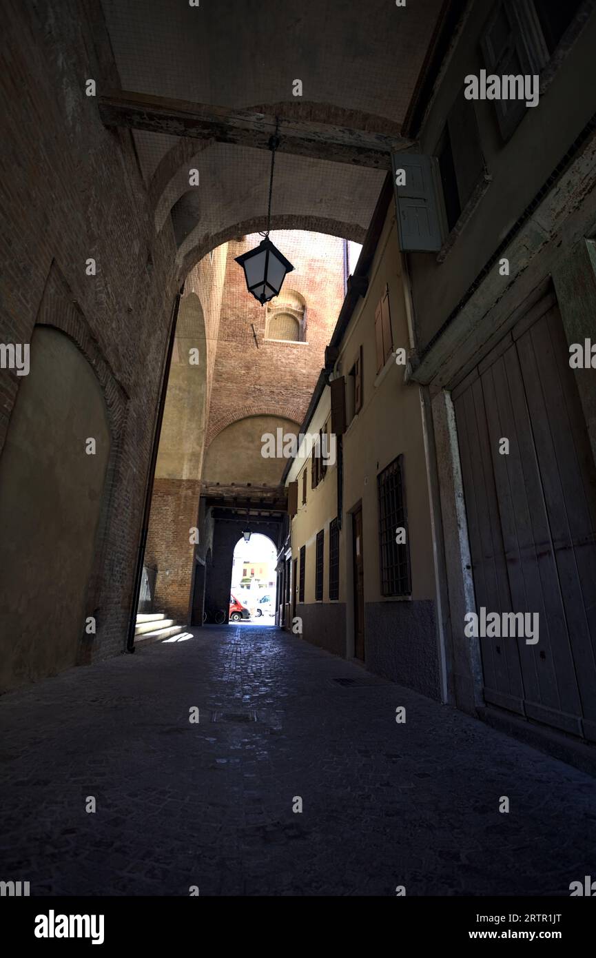 Covered alleyway in a palace with windows and doors in it on a sunny ...