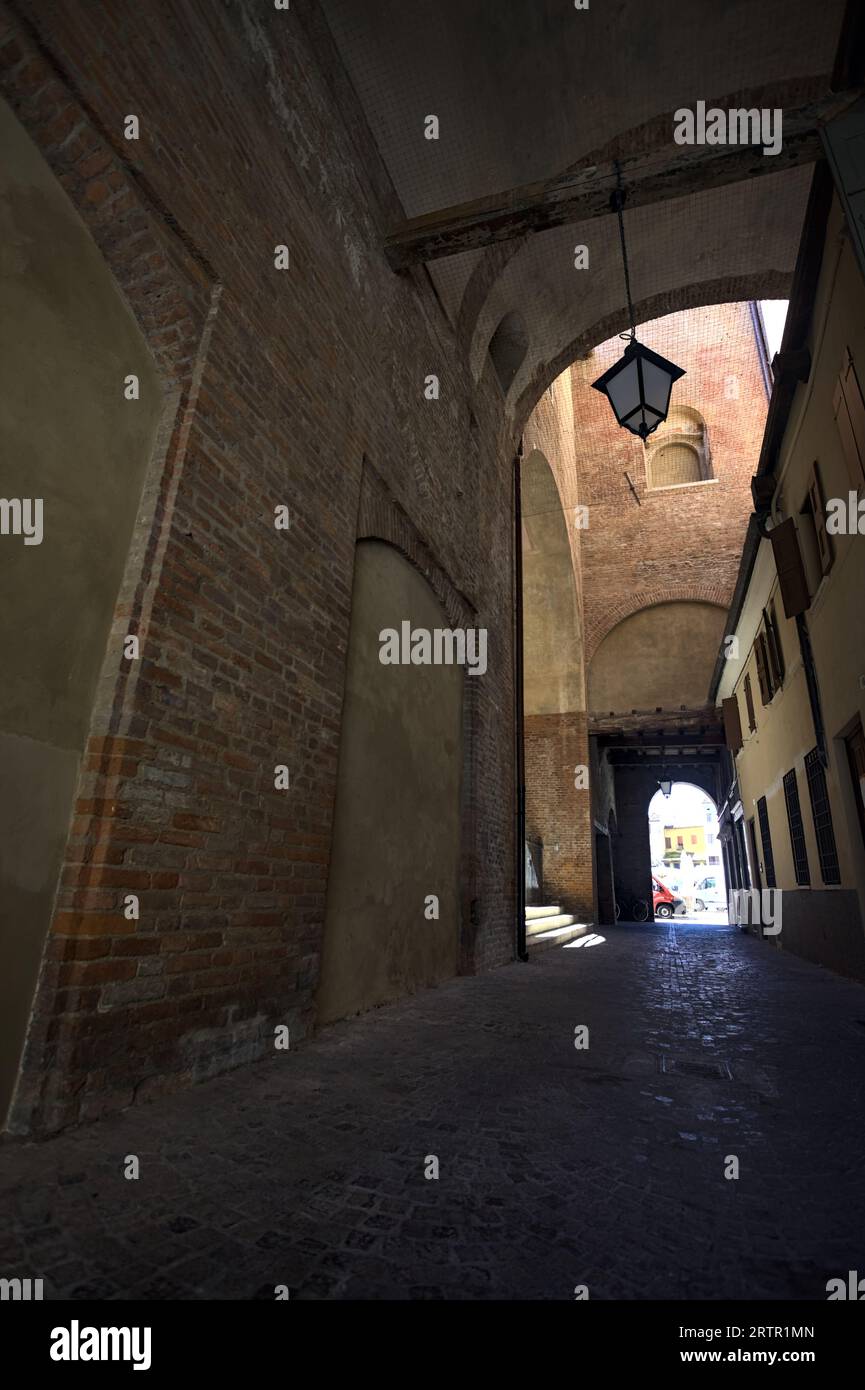Covered alleyway in a palace with windows and doors in it on a sunny ...
