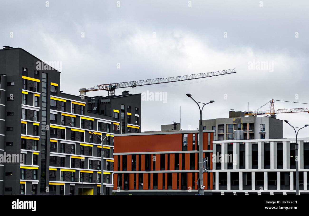 Building crane at construction site of almost finished structures in ...