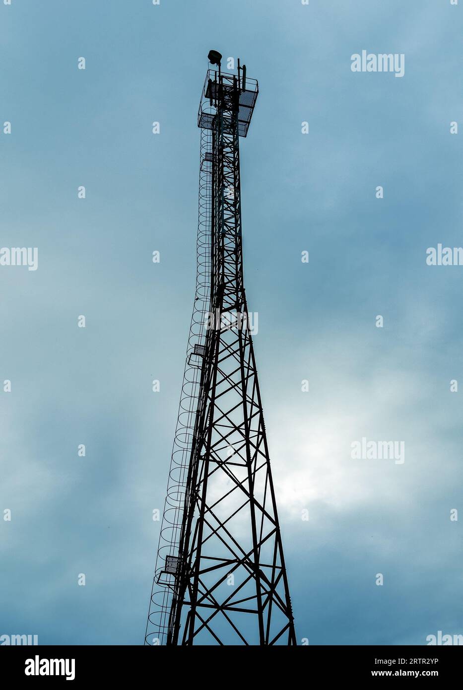 Electricity transmitting tower over sky Stock Photo - Alamy