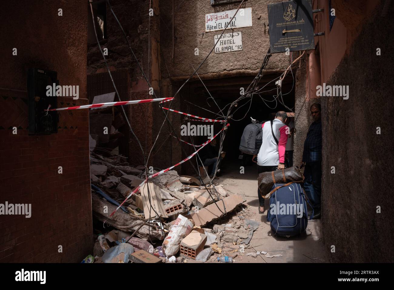 A tourist walks with luggage next to the rubble at the old town in ...