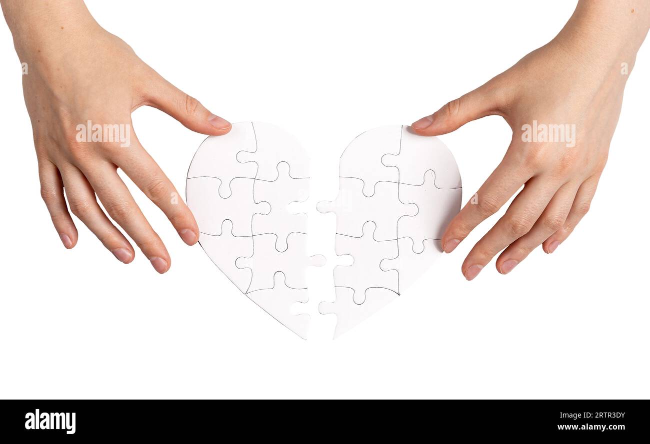 Hands matching two parts of puzzle heart, isolated on white Stock Photo ...