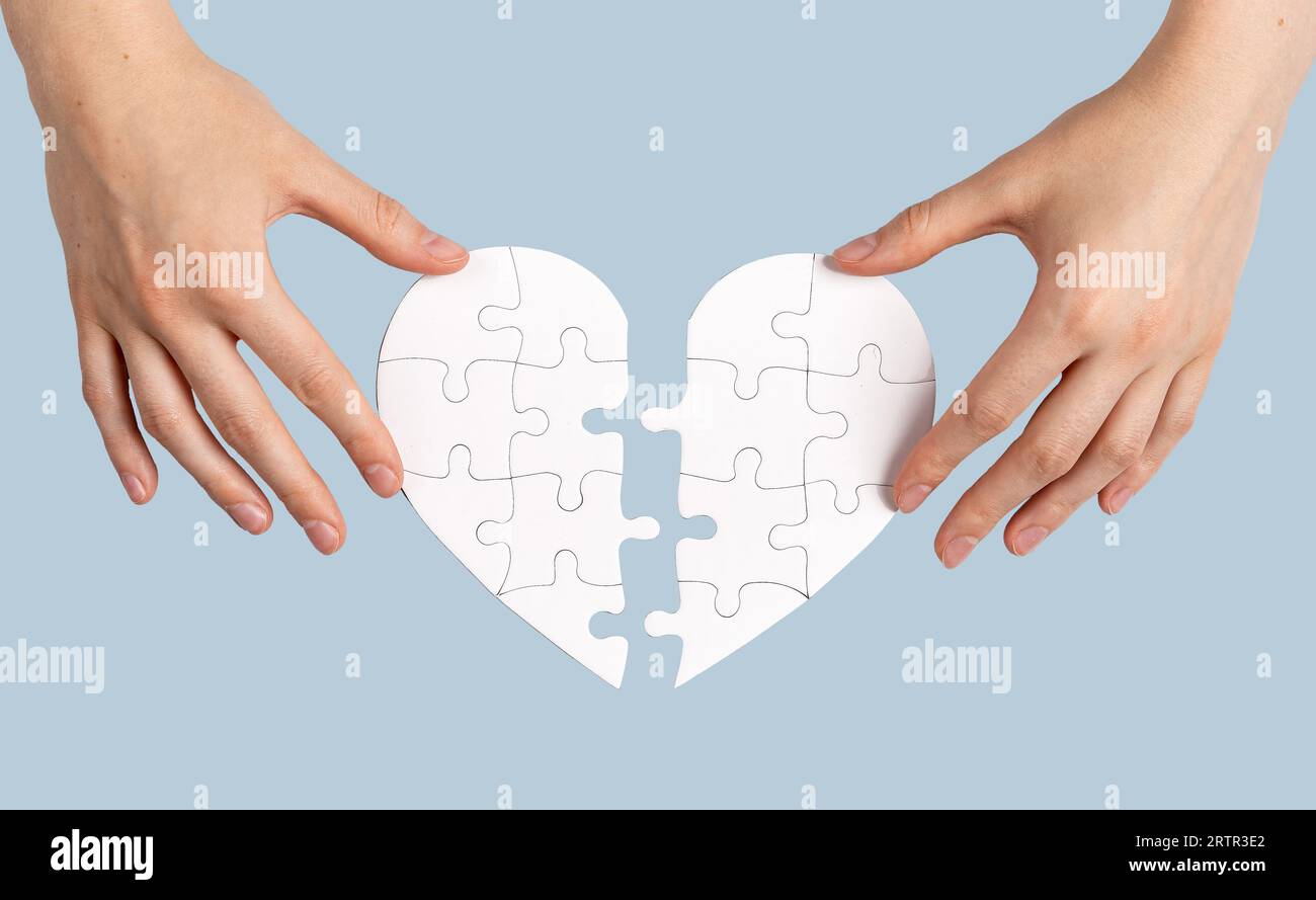 Heart puzzle hands hi-res stock photography and images - Alamy