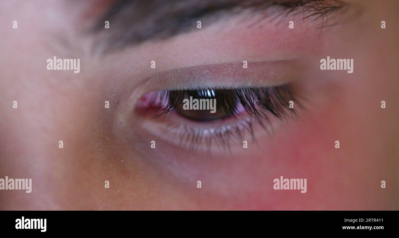 Child eyes looking at device screen. Young boy red eye staring at blue ...
