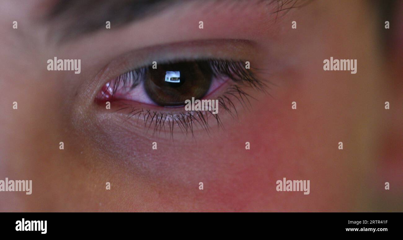 Child eyes looking at device screen. Young boy red eye staring at blue ...