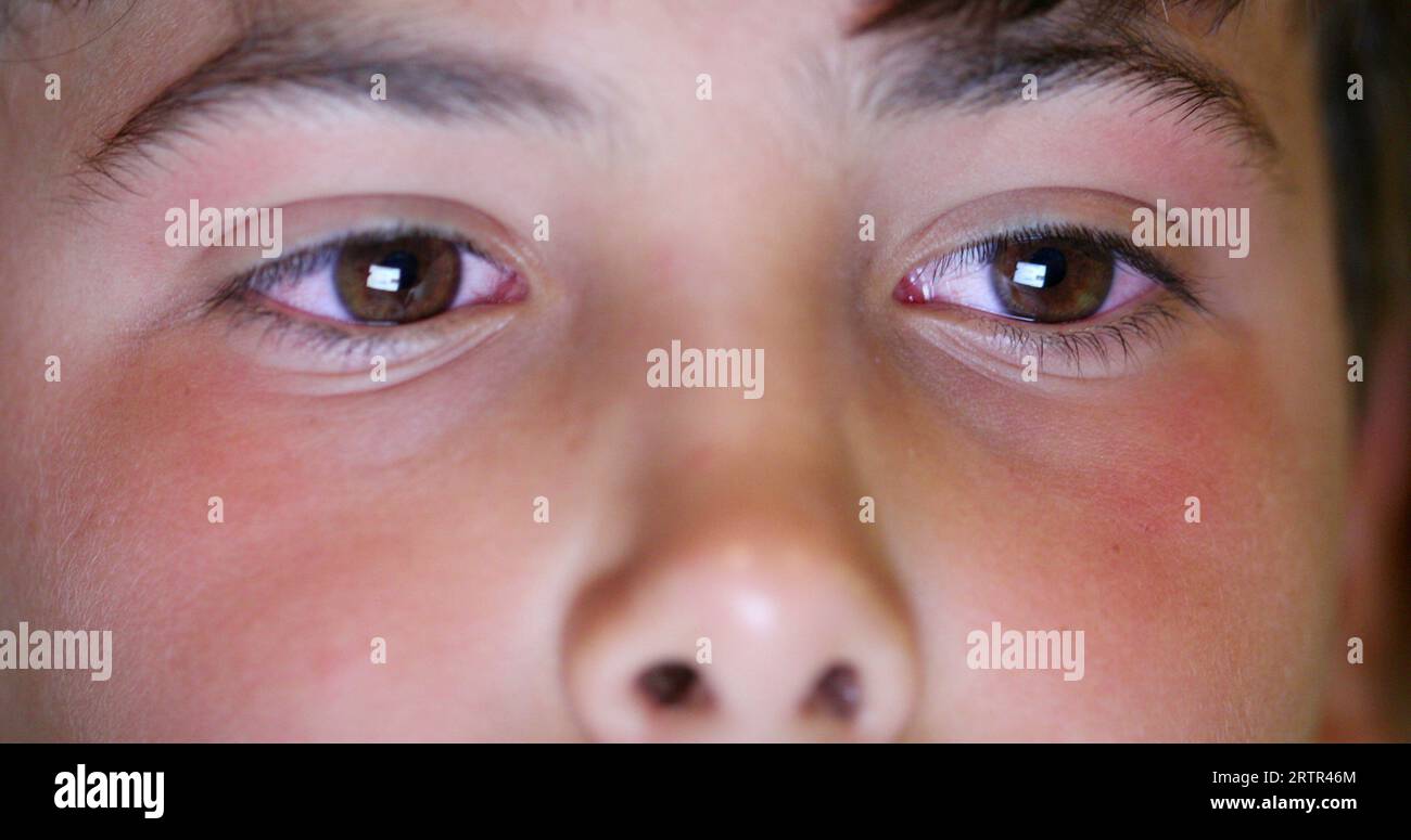 Child boy eyes looking at tablet device screen. Kid staring at blue ...