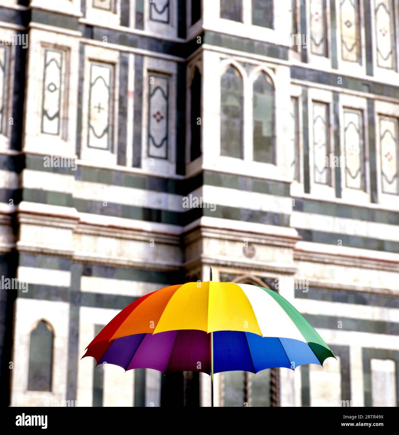 Multi colored umbrella in front of the Siena Cathedral This is a ...