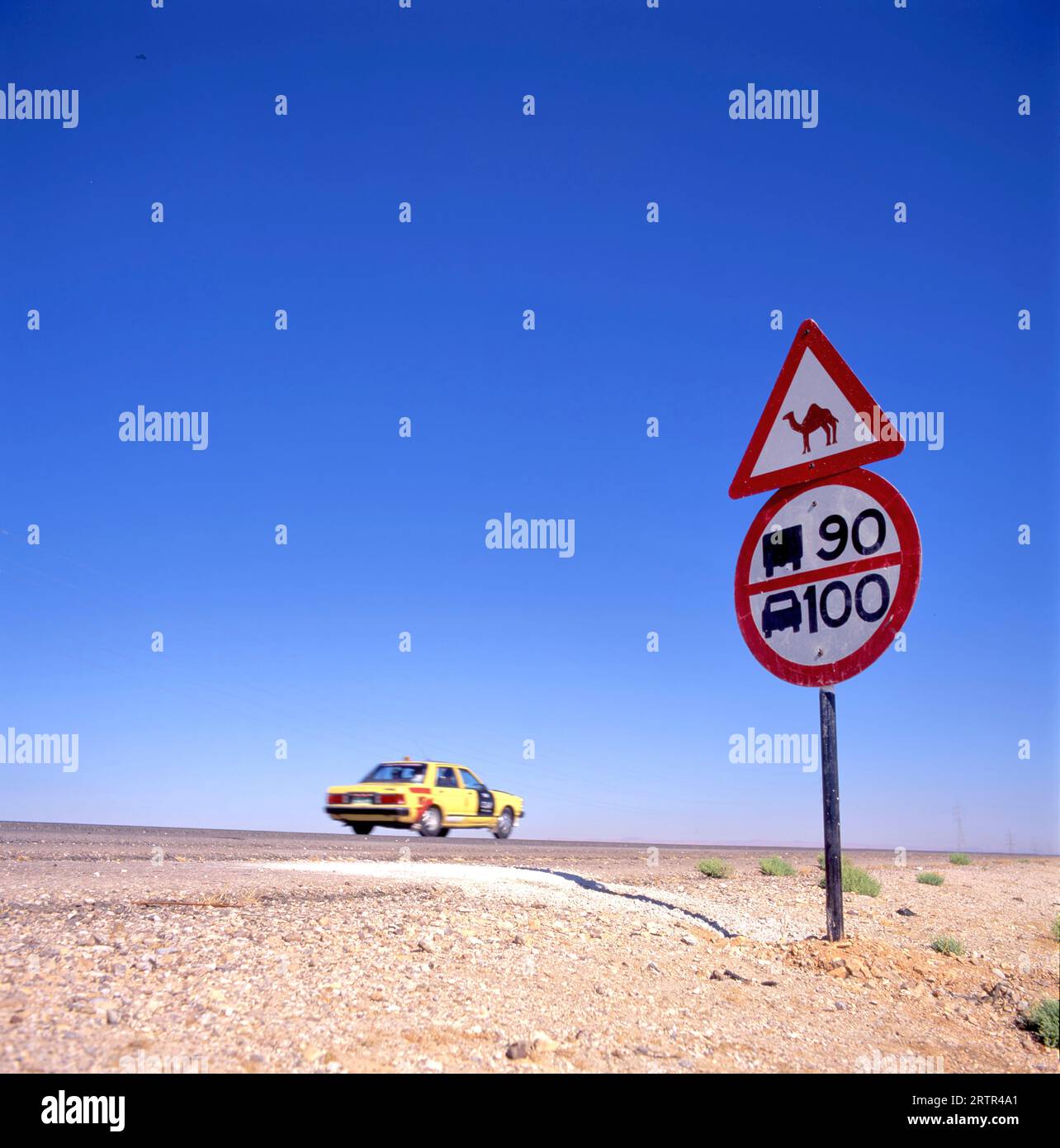 Taxi speeding in the desert on the Jordan highway towards an ...