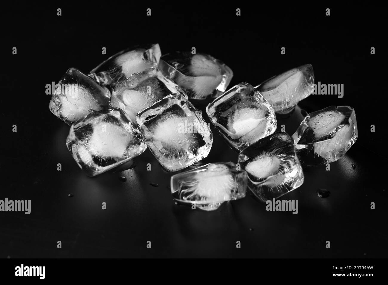 Pile ice cubes isolated Black and White Stock Photos & Images - Alamy