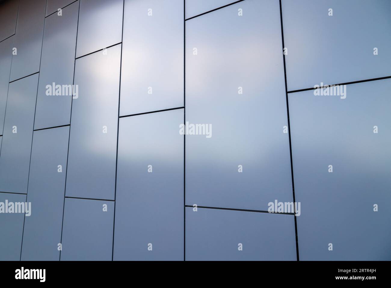 Outside wall of building covered with grayish blue painted metal ...