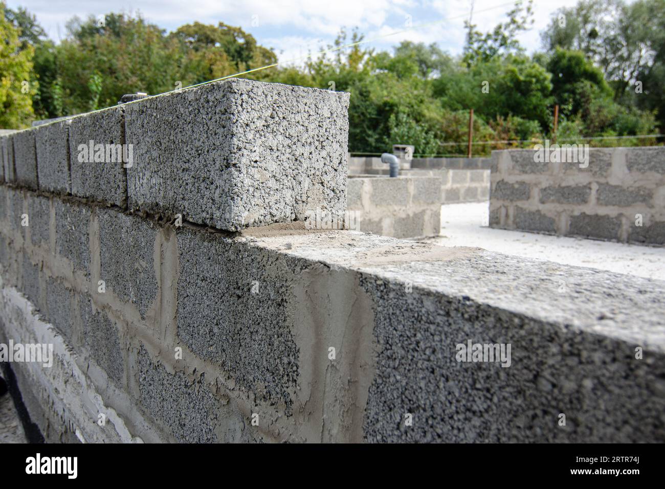 Laying of expanded clay concrete blocks during the construction of a ...
