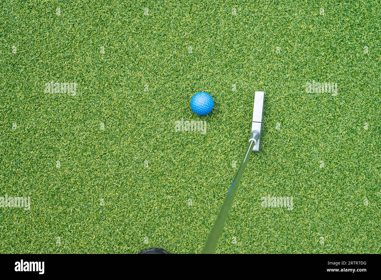 Miniature golf putter by blue ball Stock Photo - Alamy