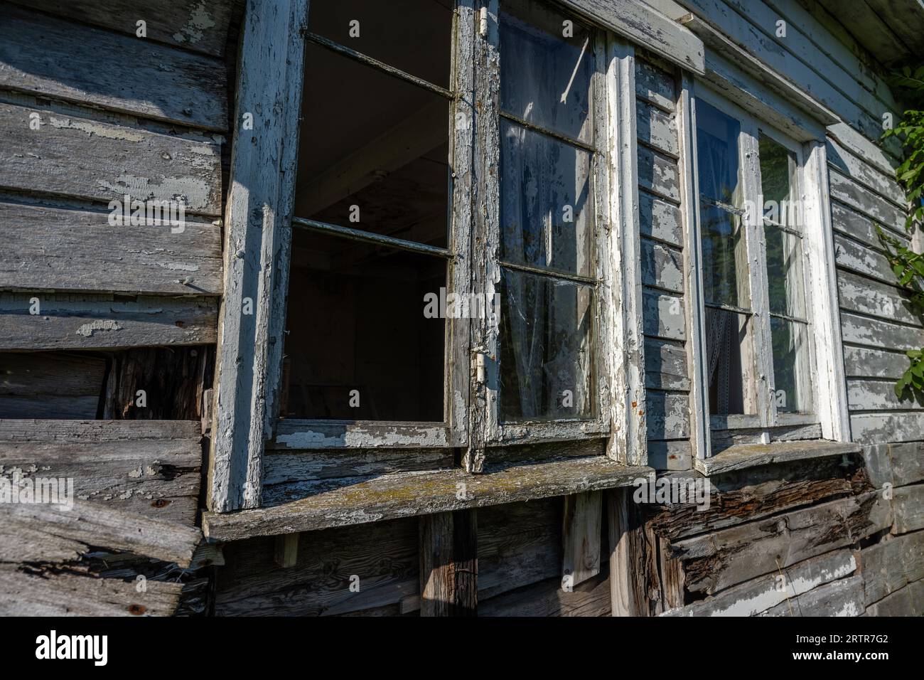 Windows of an old abandoned white wooden house Stock Photo - Alamy