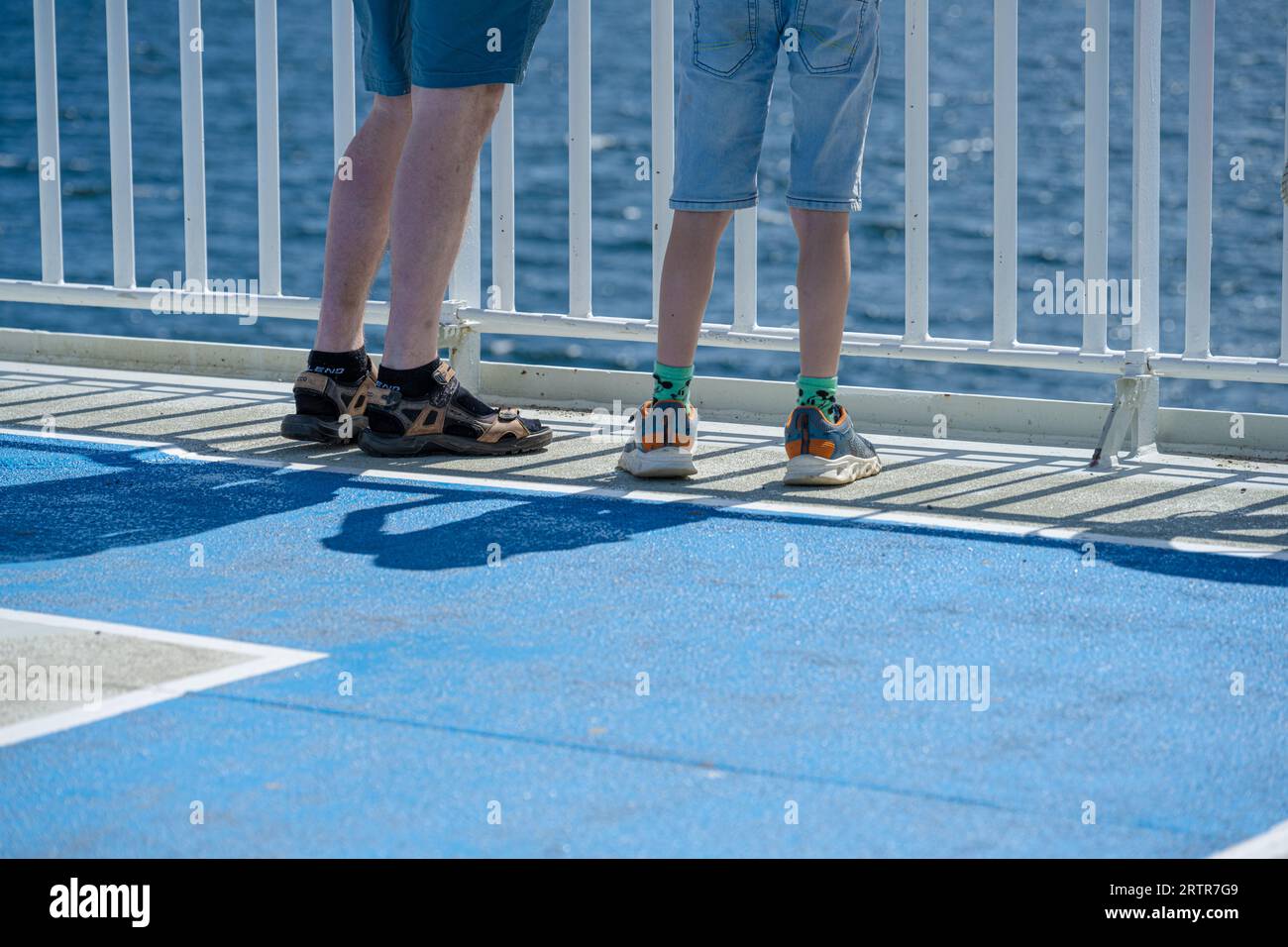Grown up with socks in sandals and kid with sneakers Stock Photo - Alamy