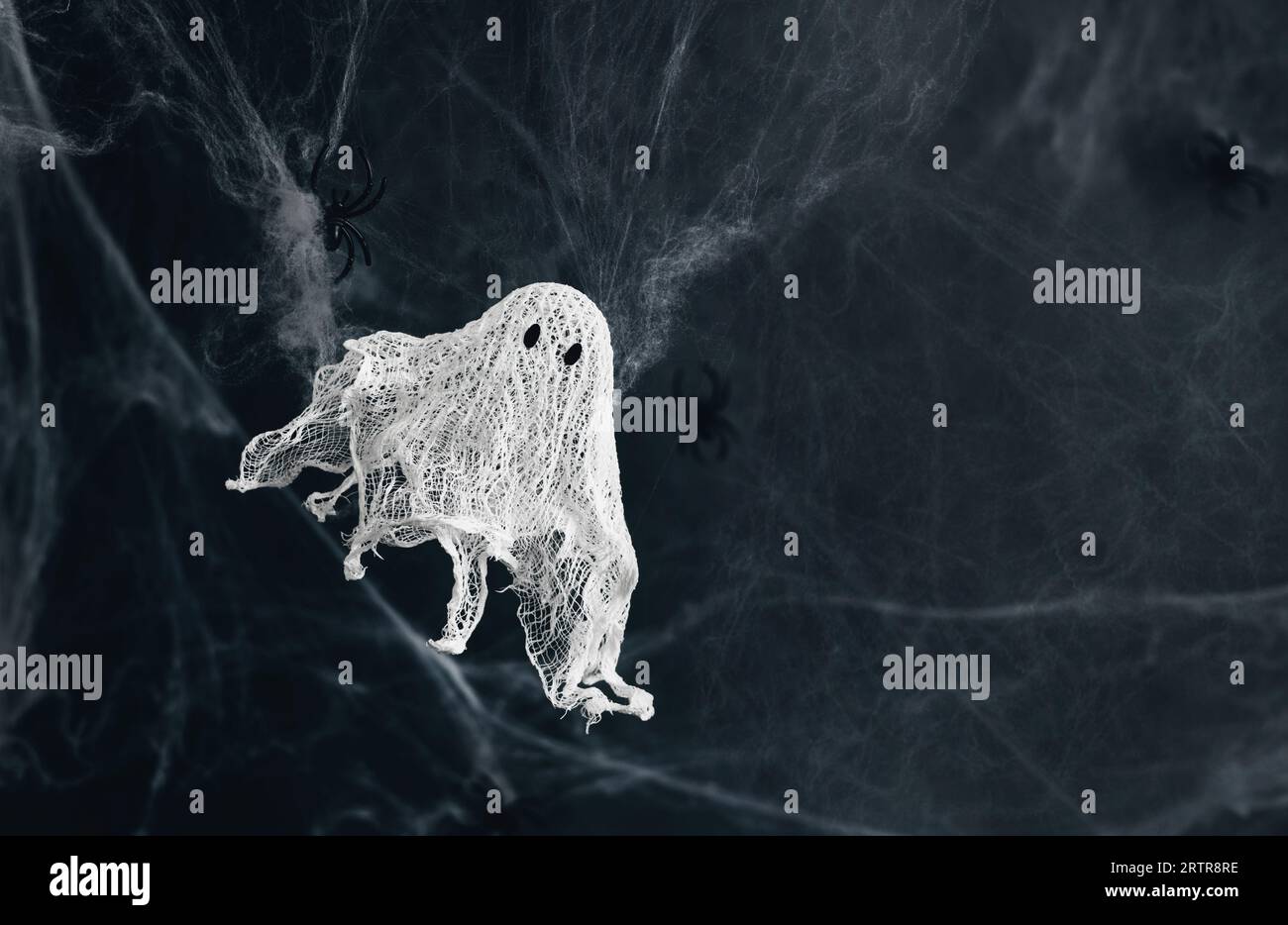 Cute ghost made of gauze and starch on dark gray background with ...