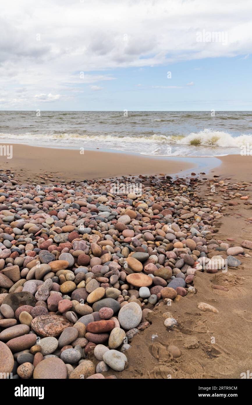 Coastal landscape with shore water and colorful pebble. Baltic Sea ...