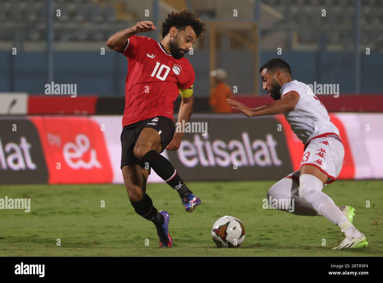 Egypt, Cairo - 12 September 2023 - Mohamed Salah of Egypt in home kit and Ali Abdi of Tunisia ...
