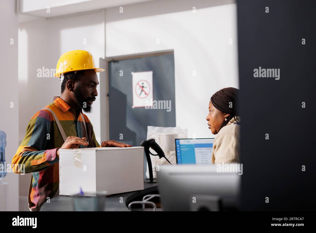 Order picker asking warehouse manager for delivery invoice while ...