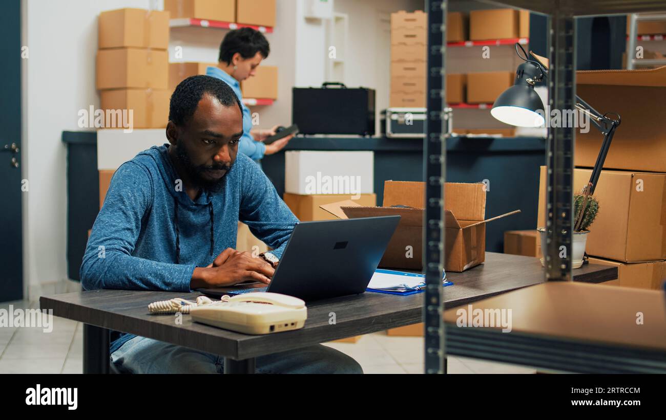 Male entrepreneur planning merchandise inventory and quality control ...