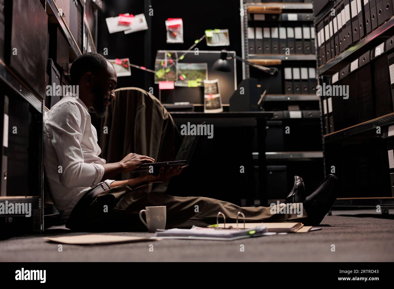 Private investigation agency worker analyzing surveillance photos on ...