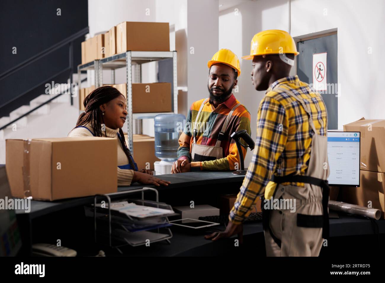 African american storehouse workers managing cardboard box registration ...