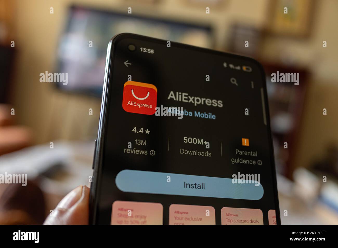 Madrid, Spain: 09 12 2023: Hand holding a smartphone with the Ali ...