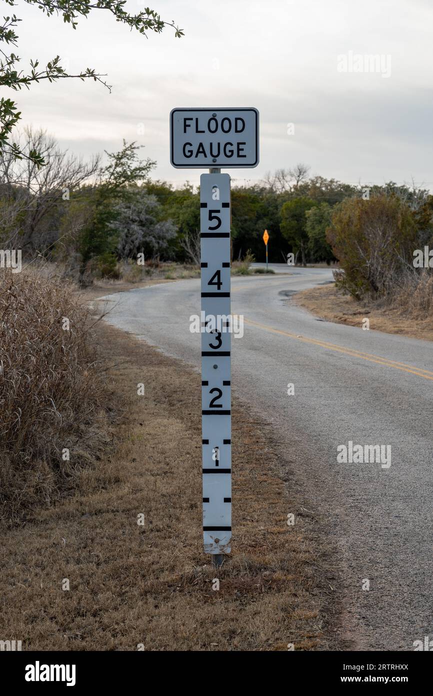 Flood Gauge Stands Tall Next To Low Laying Road in West Texas Stock ...