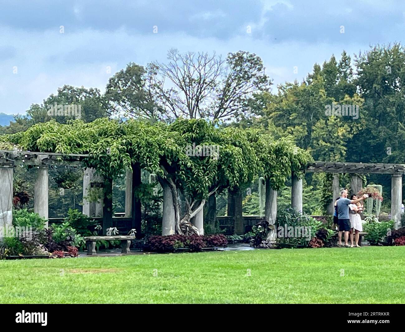Tourists visit Wave Hill‘s main Pergola. on the Great Lawn . Grounds at ...