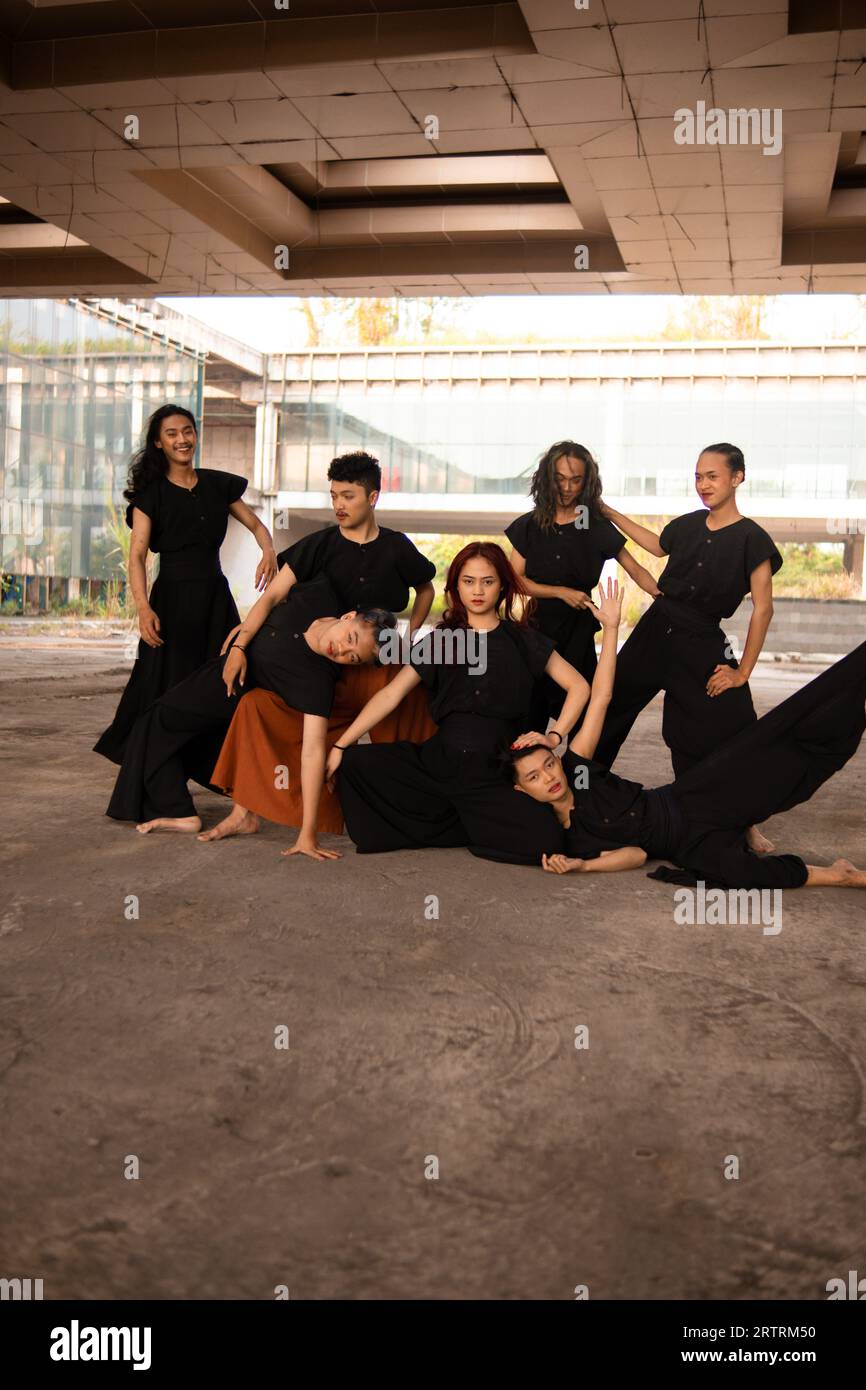 a group of Asian men posing cheerfully with their friends while wearing ...