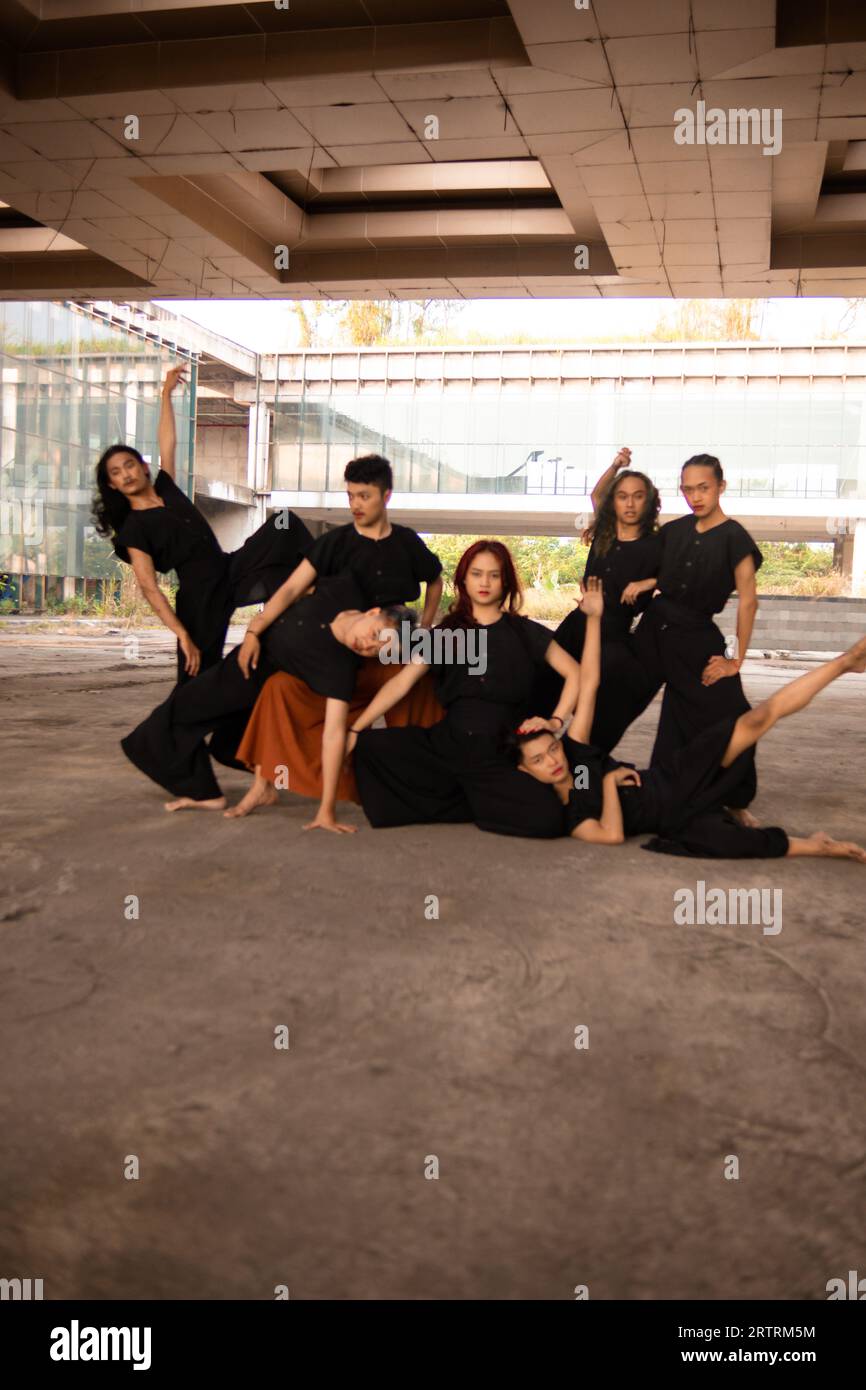 a group of Asian men posing cheerfully with their friends while wearing ...