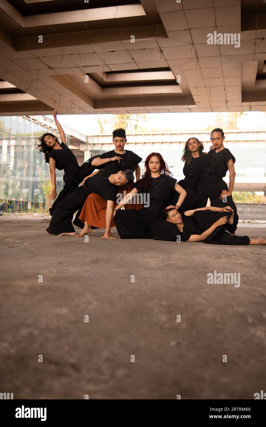 a group of Asian men posing cheerfully with their friends while wearing ...