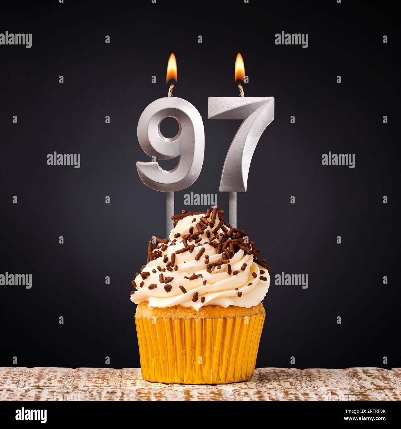 Birthday candle number 97 - Anniversary cupcake on black background ...