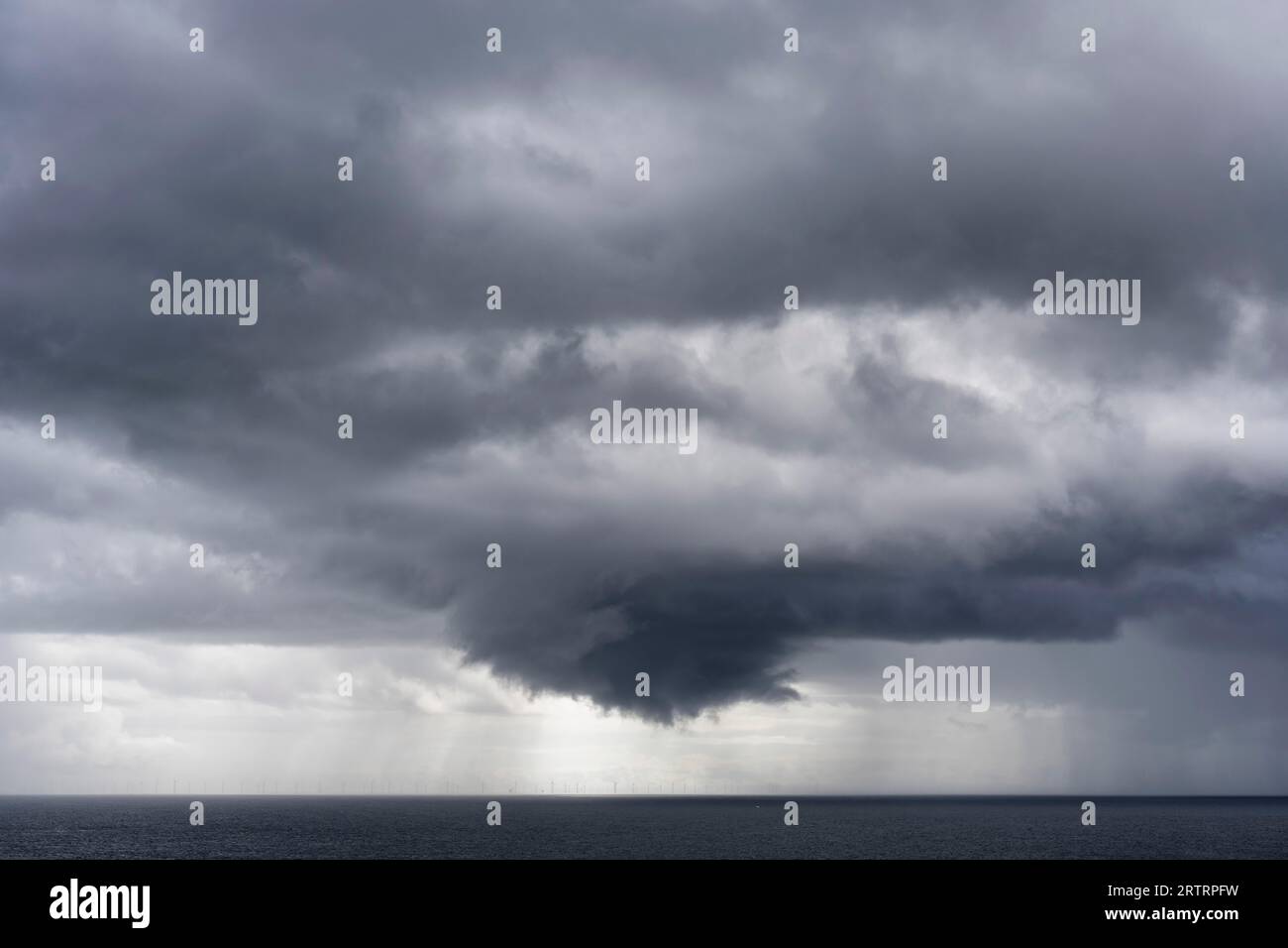 Rain clouds, heavy rainfall over the North Sea, an offshore wind farm ...