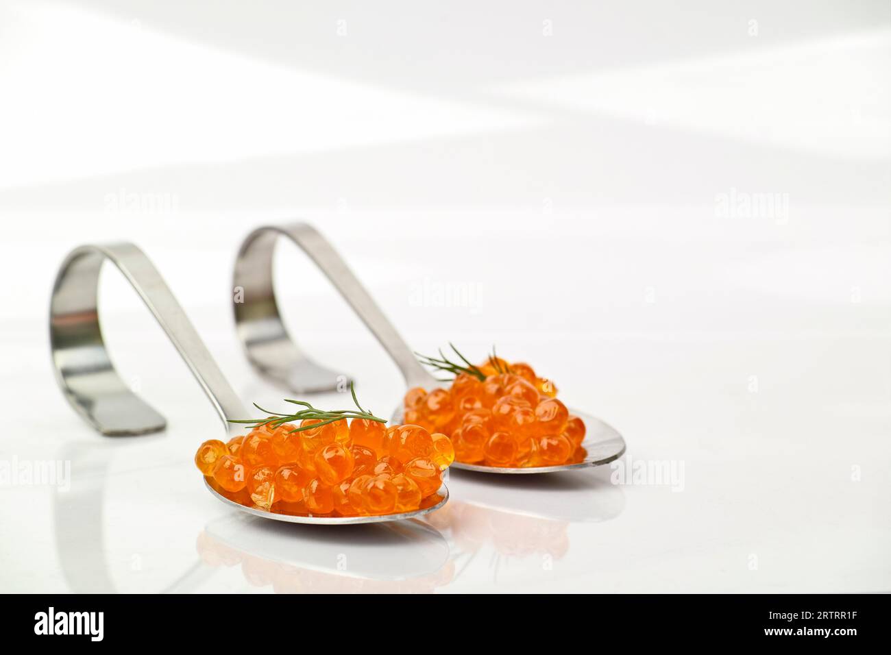 Red caviar on two curved spoons Stock Photo - Alamy