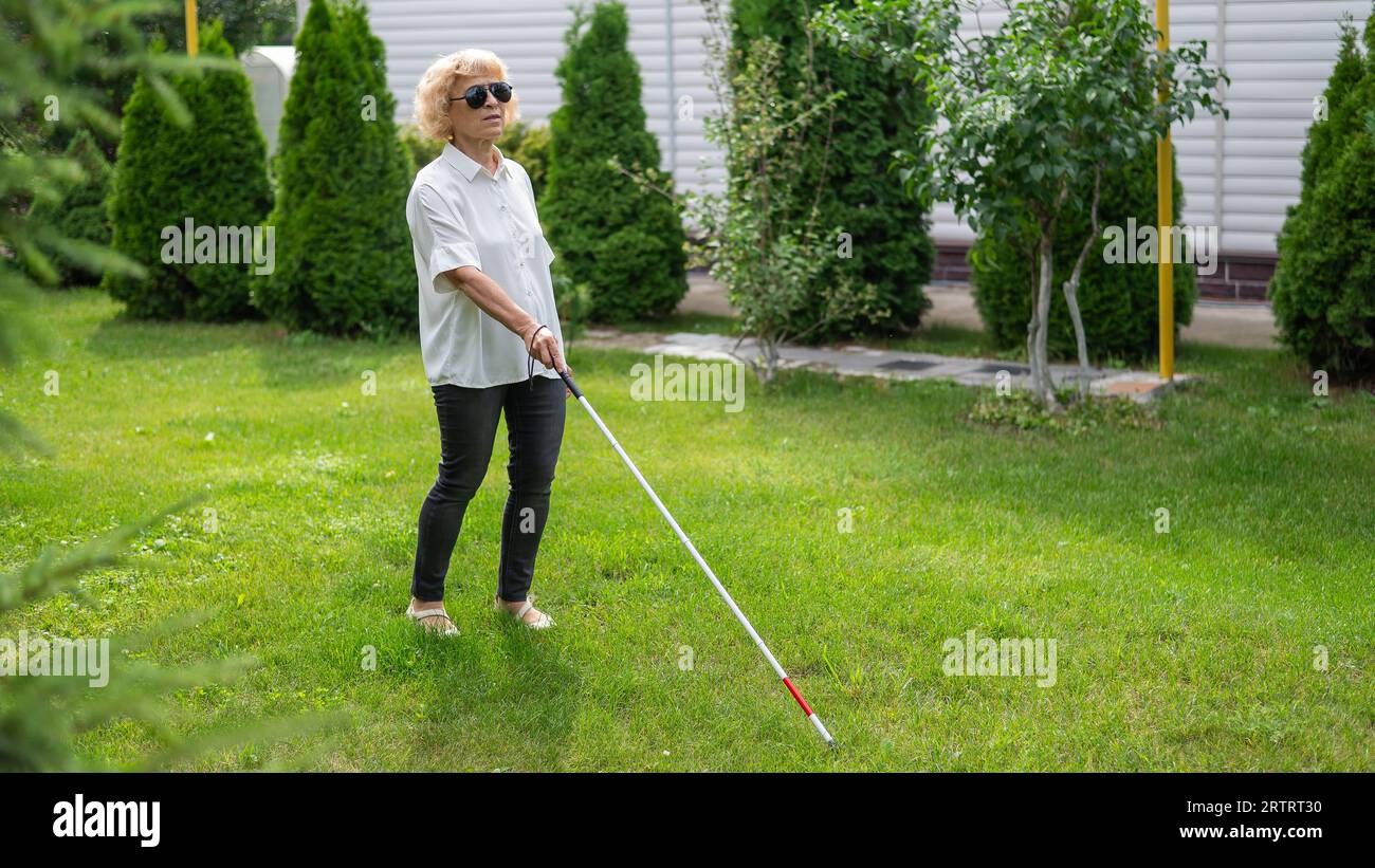 Elderly blind woman walking hi-res stock photography and images - Alamy