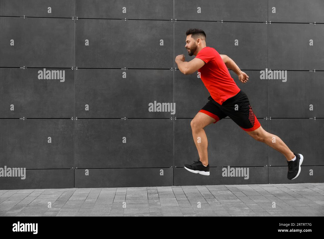Happy man running near building outdoors. Space for text Stock Photo ...