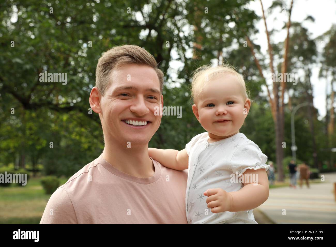 Father with his cute baby spending time together outdoors Stock Photo ...