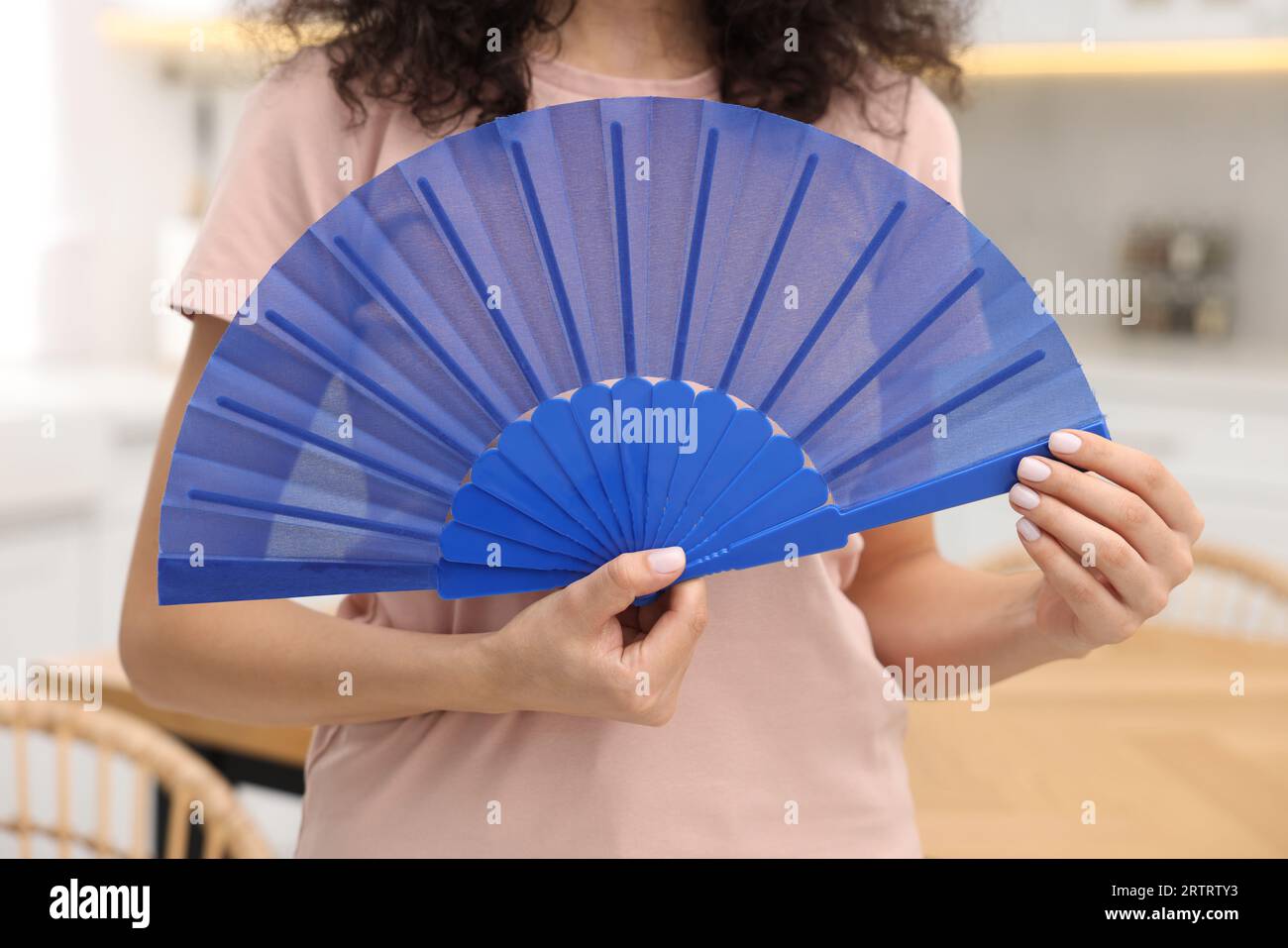Woman using handheld fan hi-res stock photography and images - Alamy