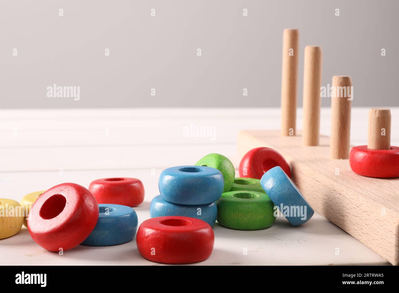 Motor skills development. Stacking and counting game pieces on white ...