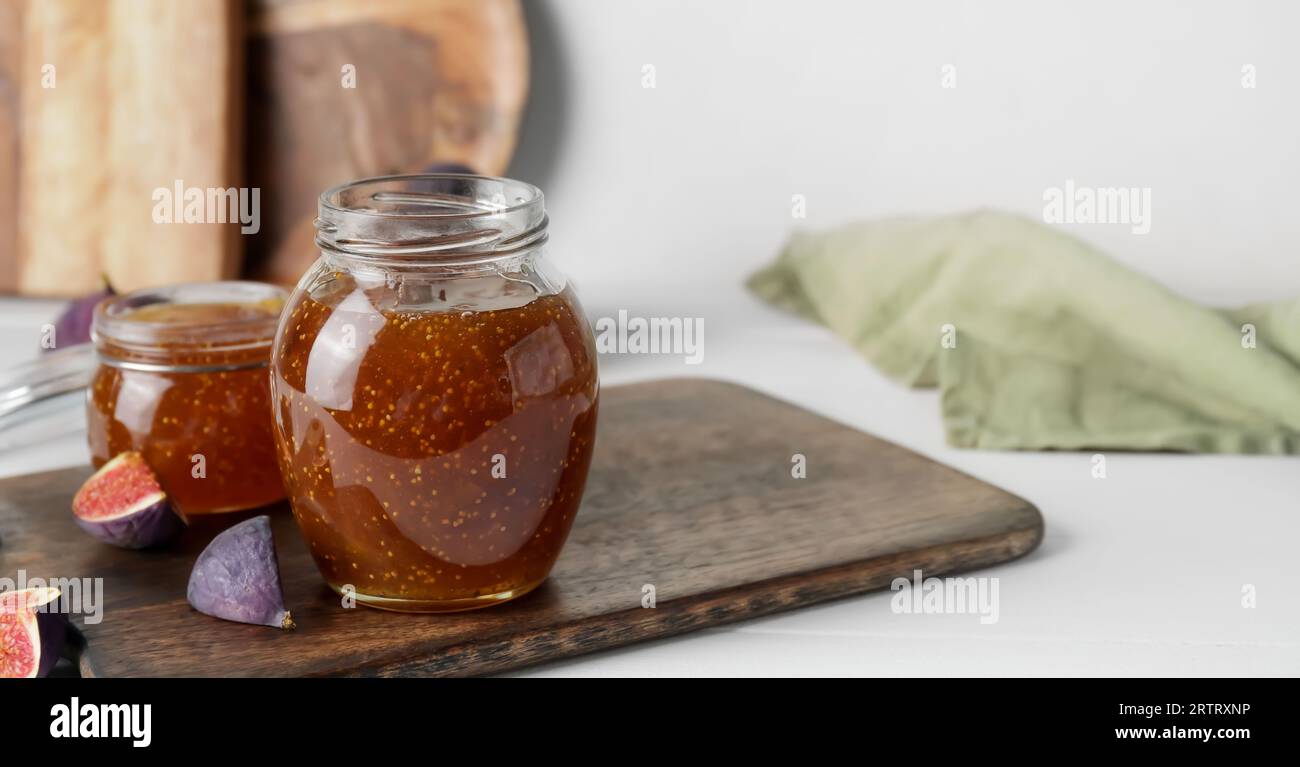 Jars of sweet fig jam on white table Stock Photo - Alamy