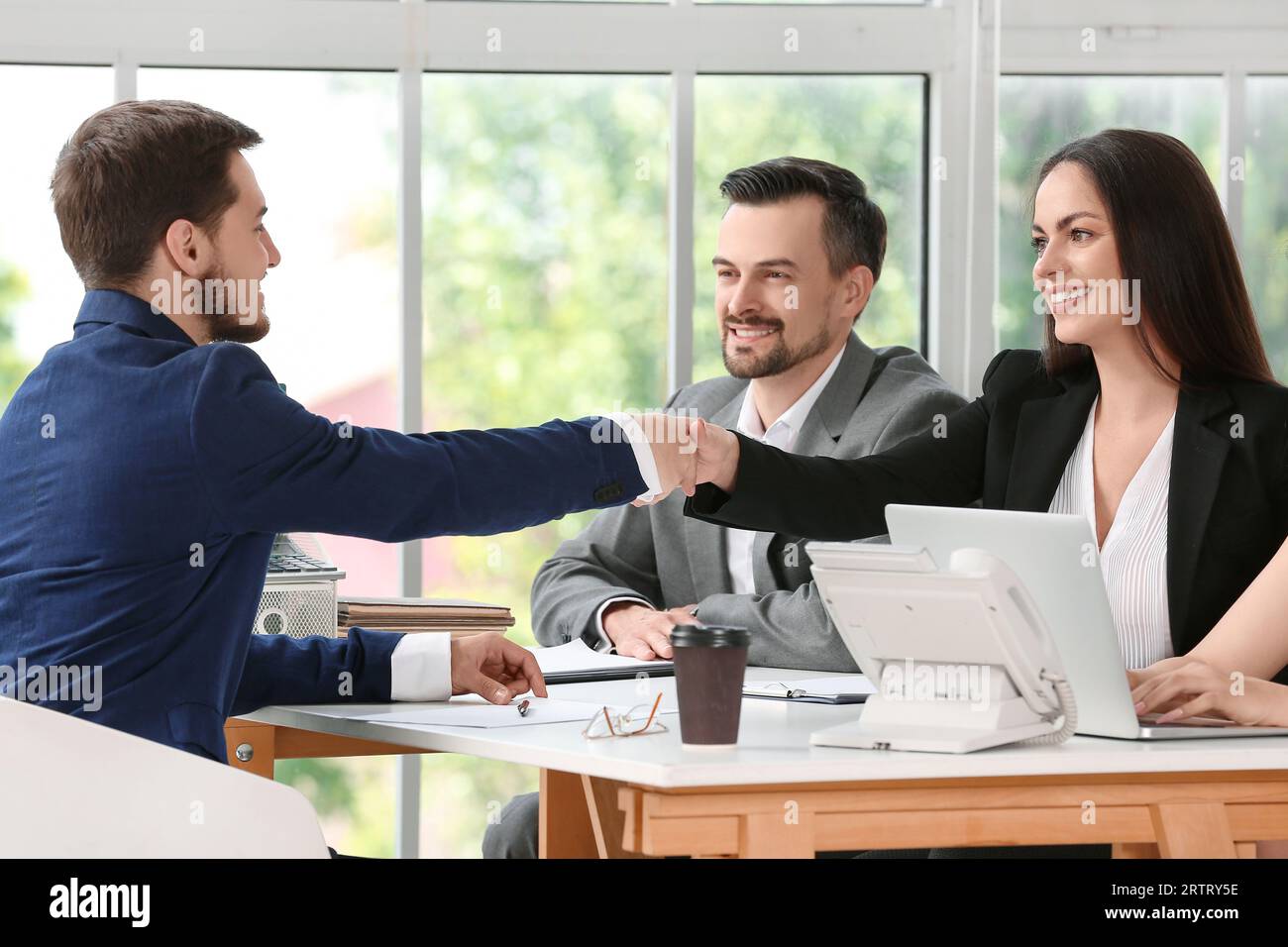 Human resources manager shaking hands with male applicant in office ...