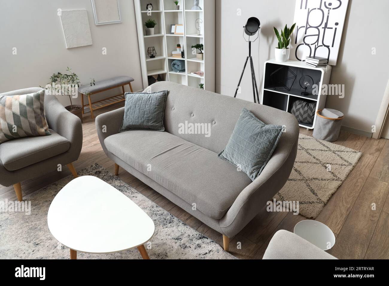 Interior of light living room with sofa and coffee table Stock Photo ...