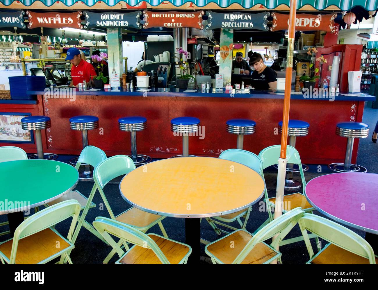 Colorful tables and food counter with stools at the Farmers Market in ...