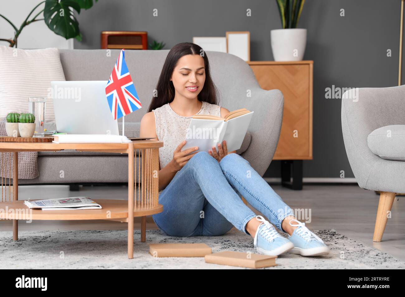 Young woman with book learning English language online at home Stock ...