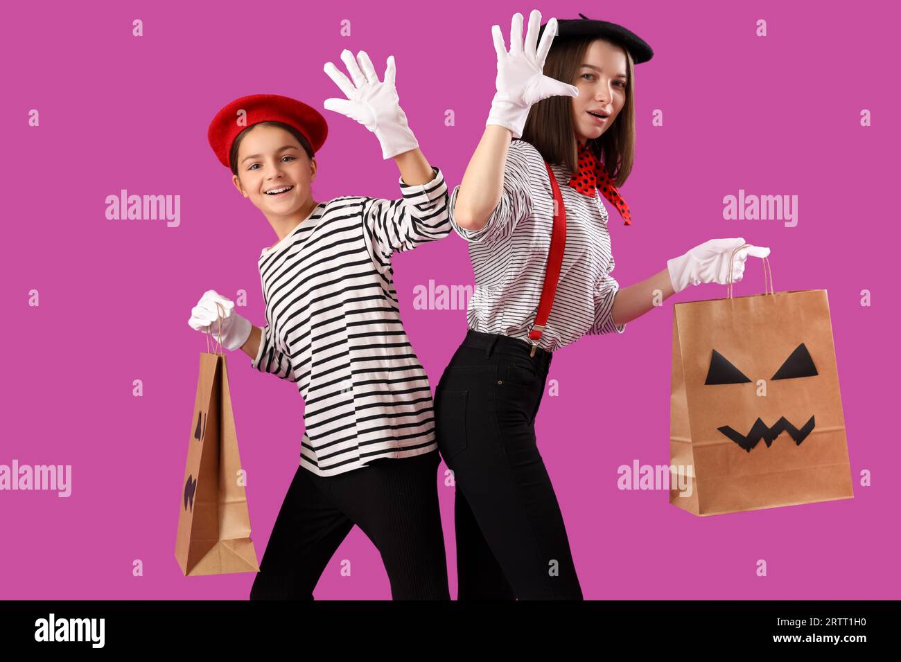 Little girl with her mother dressed for Halloween as mimes with gift ...