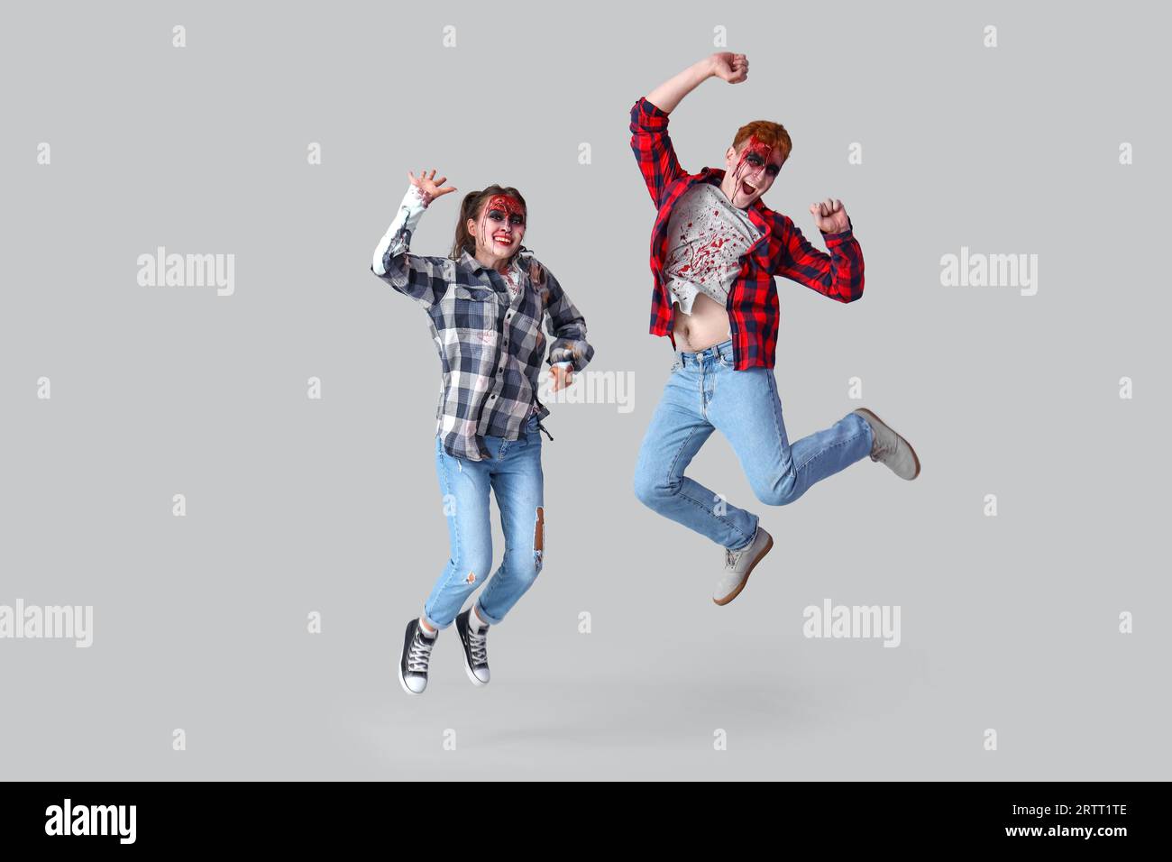 Scary zombies jumping on grey background Stock Photo - Alamy