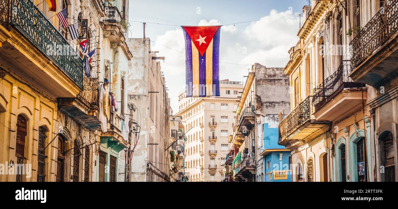 A cuban flag with holes waves over a street in Central Havana. La ...